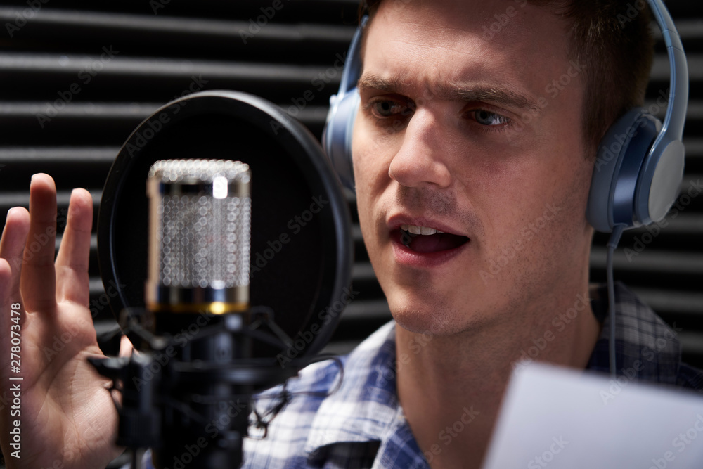 Man In Recording Studio Talking Into Microphone Stock Photo | Adobe Stock