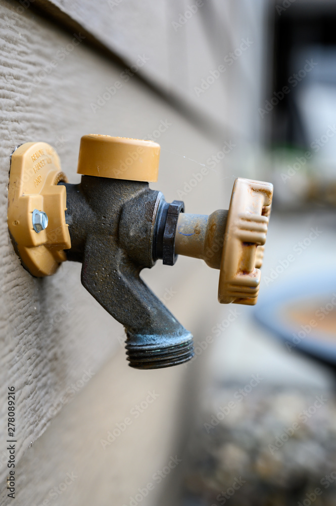 Handle-Operated Freezeless Residential Wall Hydrant mounted on exterior ...