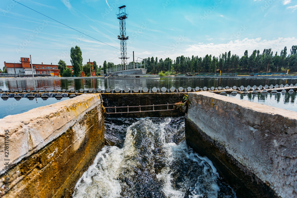 Modern urban sewage treatment plant. Purified water flowing from ...