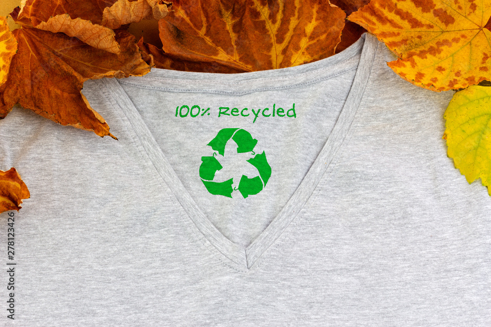 Recycle clothes icon on t shirt with 100% Recycled text on autumn ...