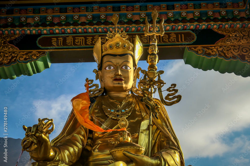 Angry looking Hindu God, covered with gold, with a mustache. Figure is ...