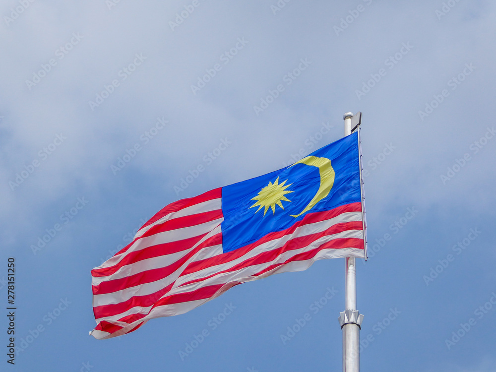 A Malaysian flag waving proudly on the mast. Flag consists of red and ...