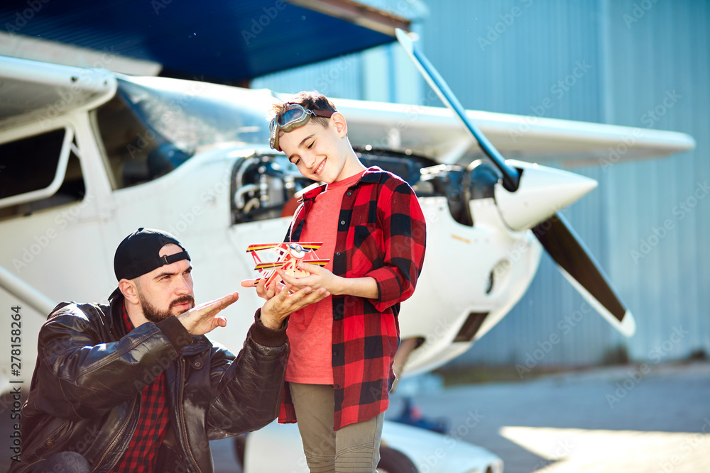 aeromodelling male instructor in black pilot jacket gives last ...