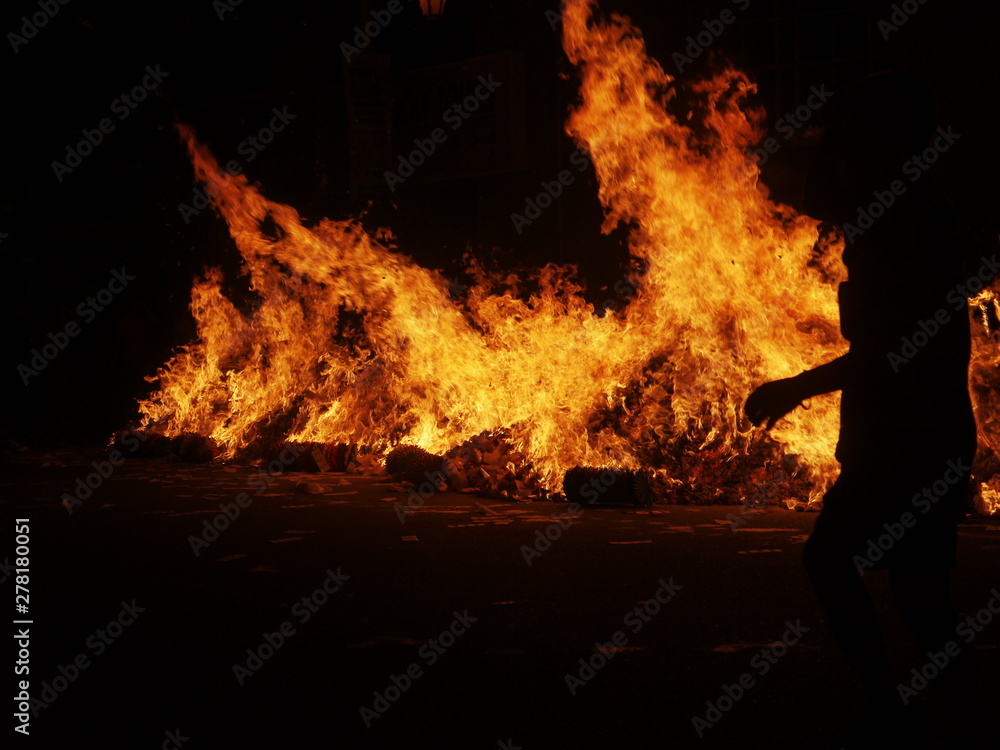 Burning effigies flame the fire during a Hungry Ghost Festival in ...