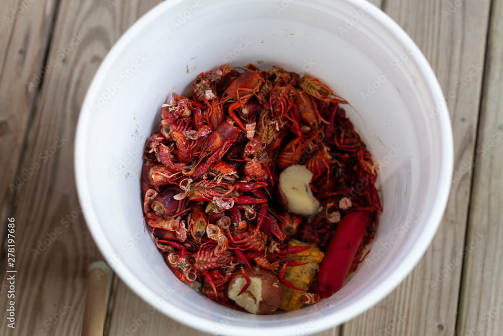 Crawfish heads and tails in white bucket with corn and potatoes Stock ...