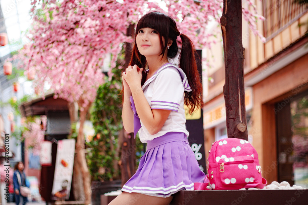 Portrait of cute Japanese female student with Cherry blossom tree in ...