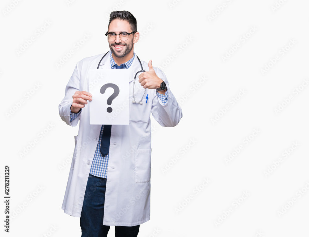 Handsome young doctor man holding paper with question mark over ...