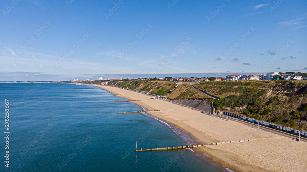An aerial view of a majestic sandy beach with crystal blue water sea ...