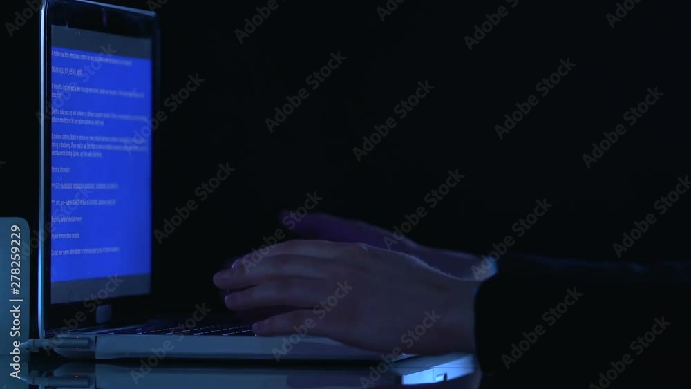 Hands stop typing when blue screen on laptop appears, virus in ...