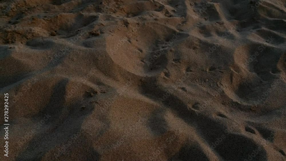 Rotating Wide angle beach sand scene shot at sunset consisting of sand ...
