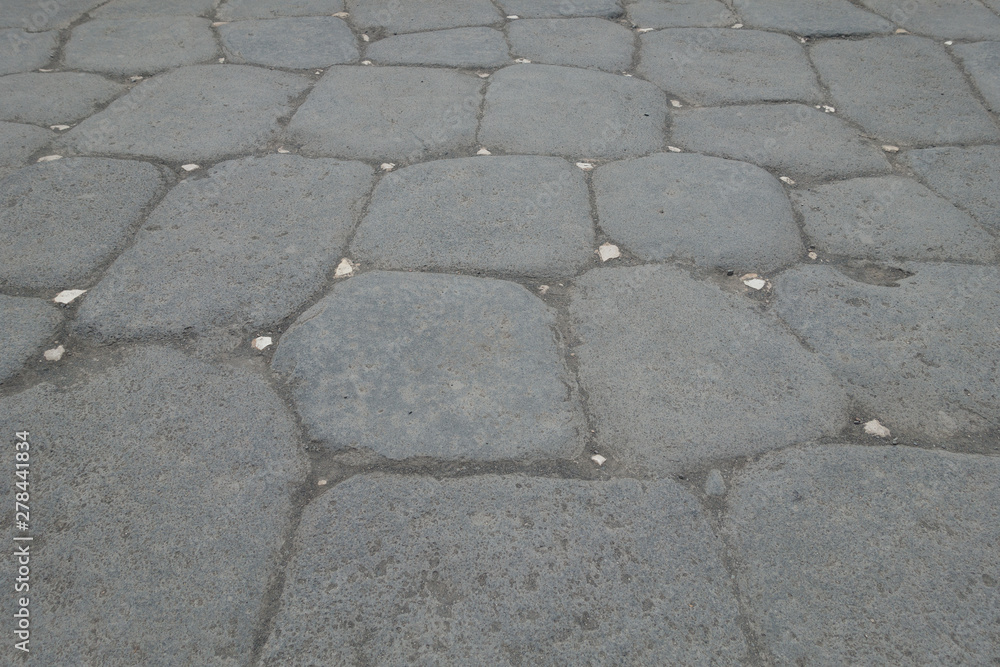 White reflective stones can be seen in a patterned roman road used to ...