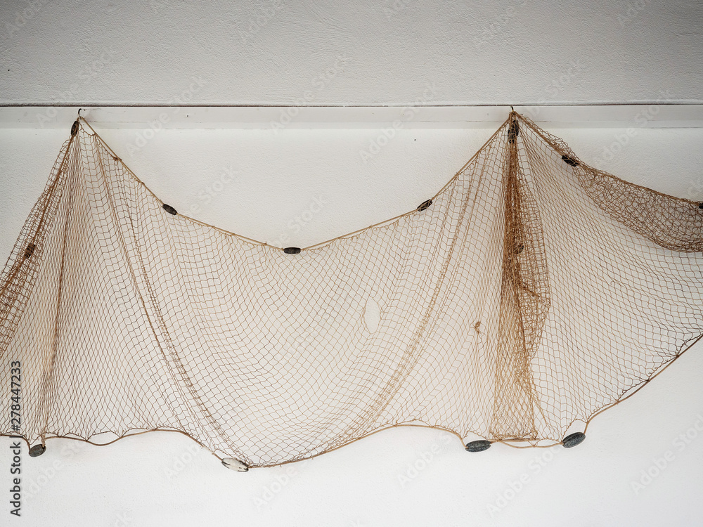 Old worn fishing net on a wall on display, Concept history and old ...