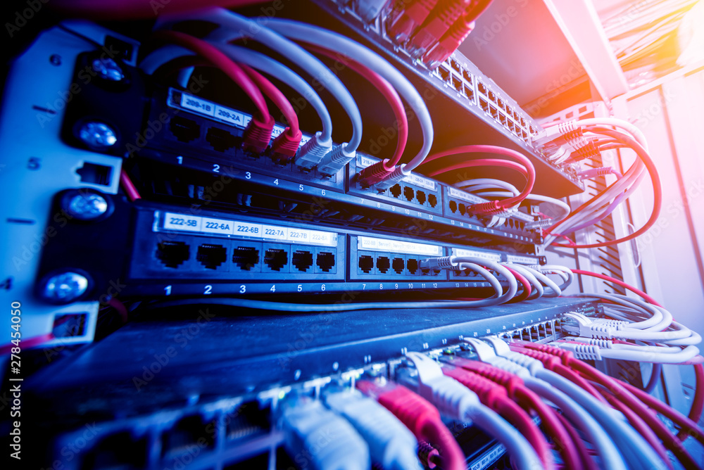 Network switch and ethernet cables in red and white colors. Data Center ...