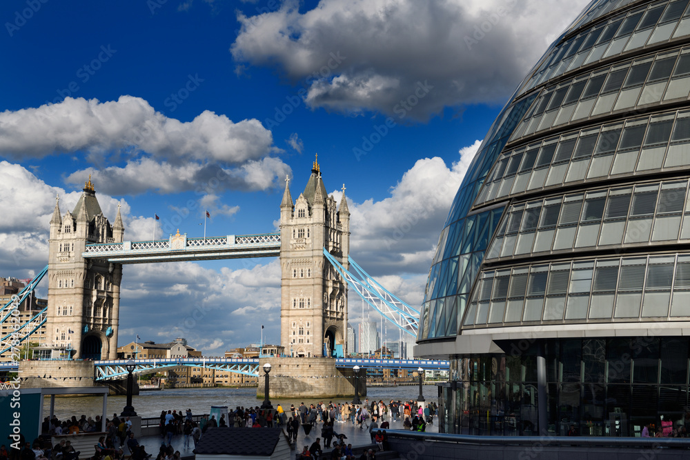 Twin stone towers of Tower Bridge over the Thames River in London with ...