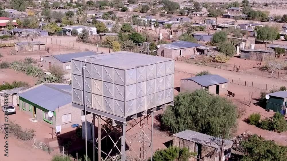 An elevated galvanized steel water tank and water reservoir in small ...