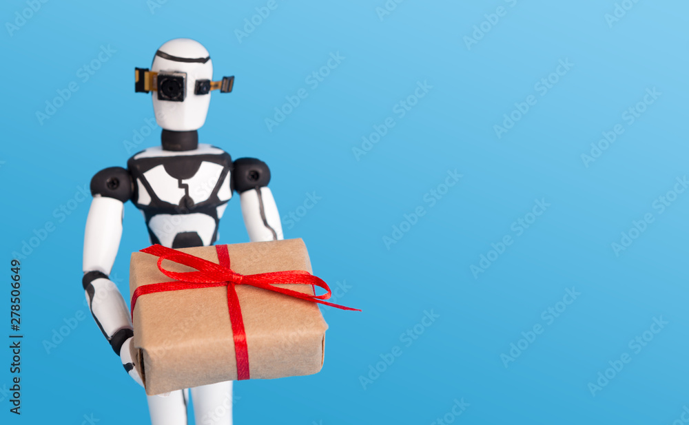 Little robot holding gift box, blue background with empty space. Stock ...