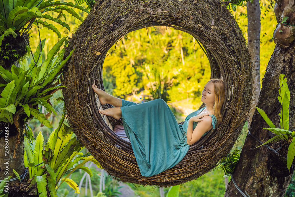 Bali trend, straw nests everywhere. Young tourist enjoying her travel ...