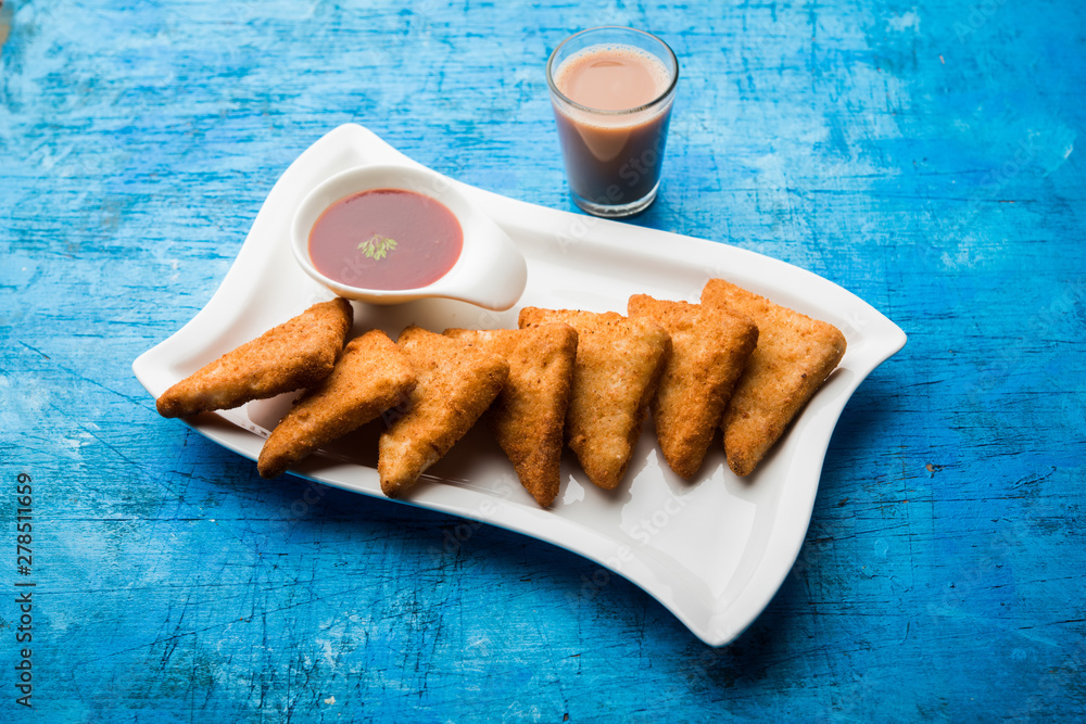 crispy Potato triangles or batata vada covered with bread crumbs and ...