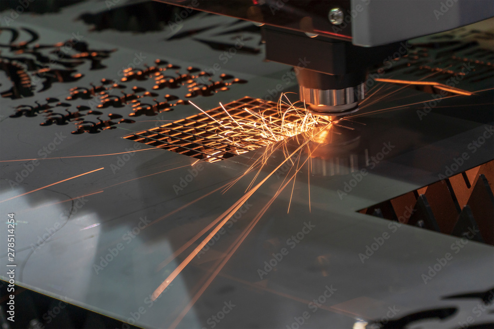 The fiber laser cutting machine cutting the sheet metal plate. The ...