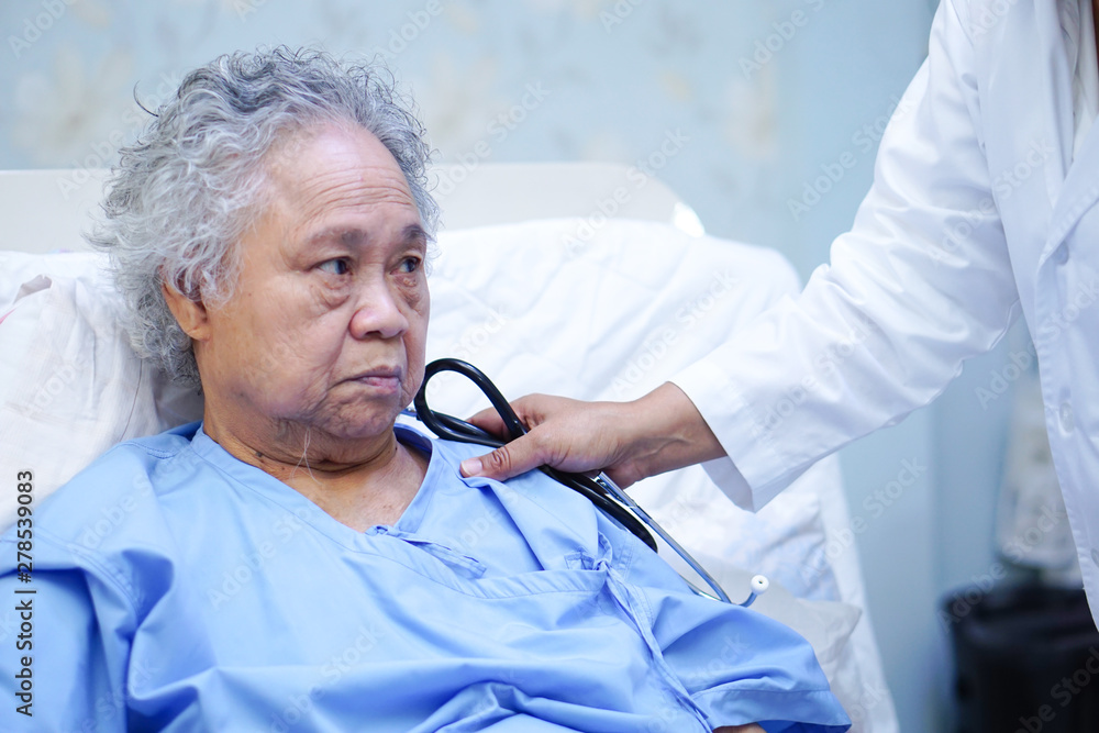 Doctor with stethoscope checking senior or elderly old lady woman ...