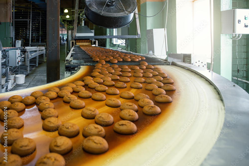 Bakery production line with sweet cookies on conveyor belt equipment ...