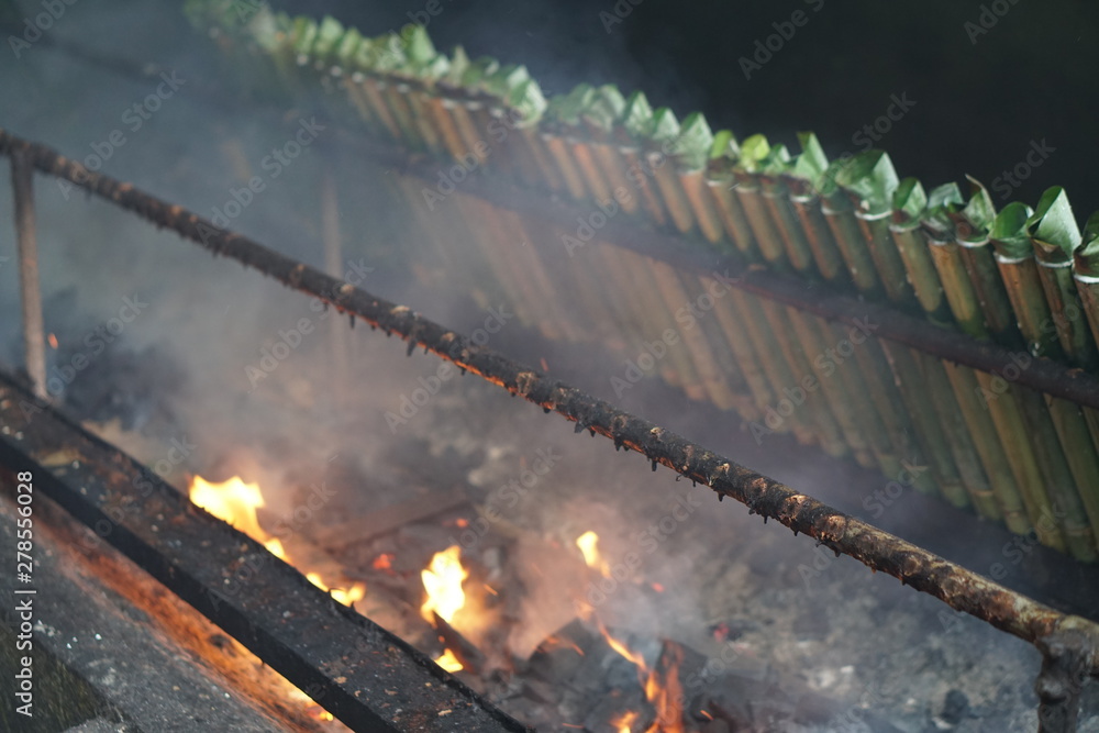Making (Lemang) glutinous rice in bamboo cooked using firewood is a ...
