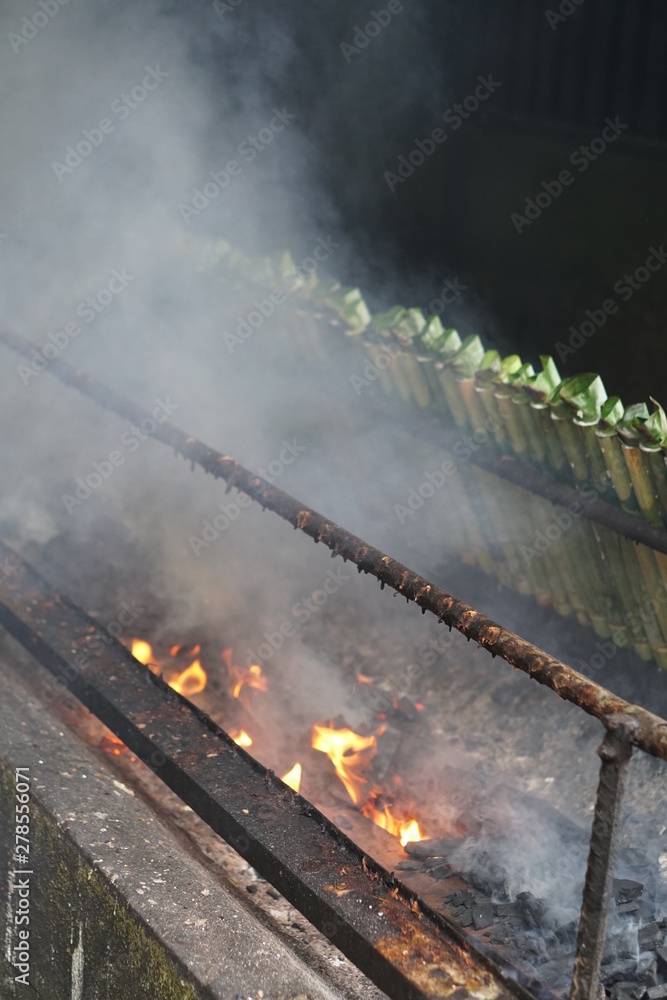 Making (Lemang) glutinous rice in bamboo cooked using firewood is a ...