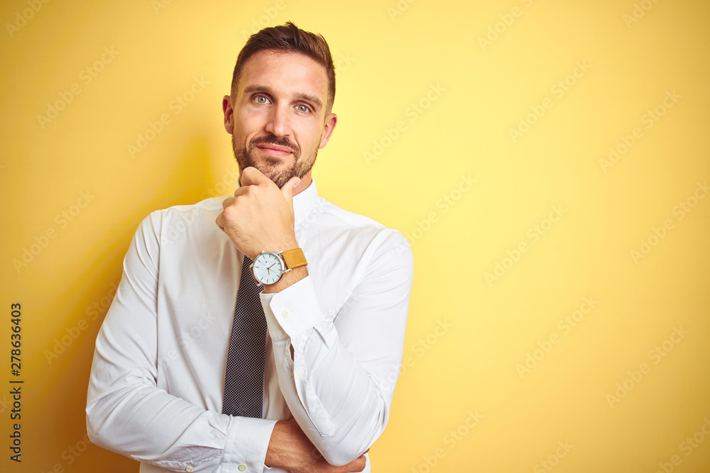 Young handsome business man wearing elegant white shirt over yellow ...