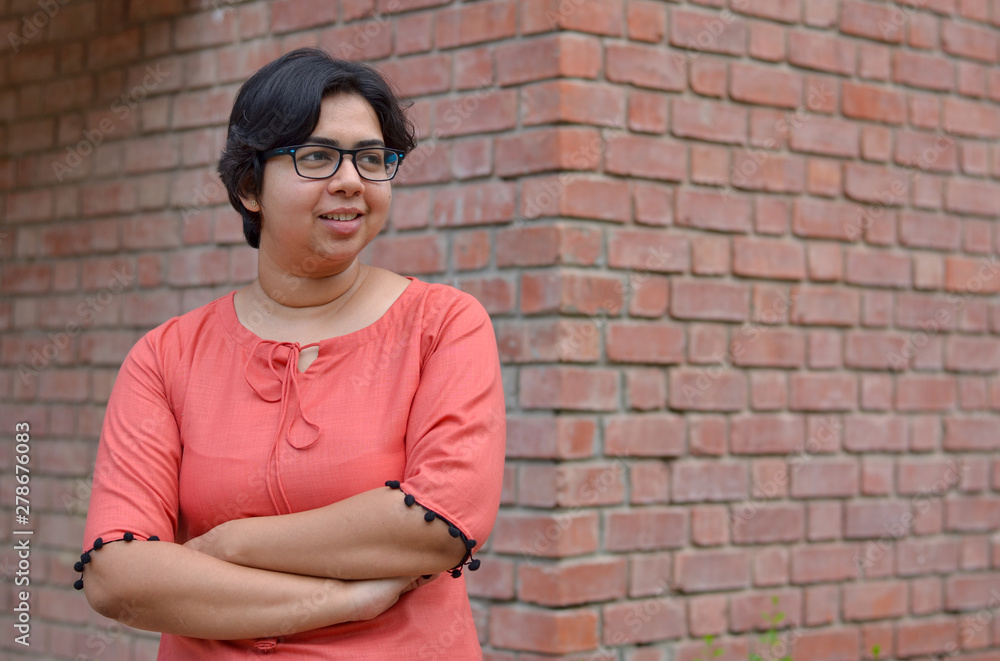 Portrait of a confident looking young Indian woman with short hair and ...