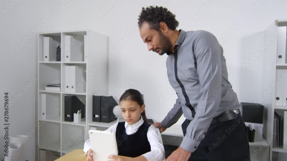 Medium shot of African American man teaching computer skills class for ...