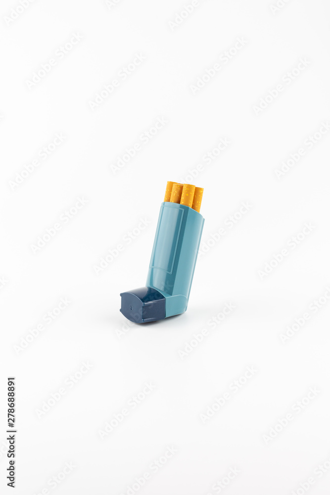 Salbutamol inhaler with cigarettes on white background ( Asthma is not ...