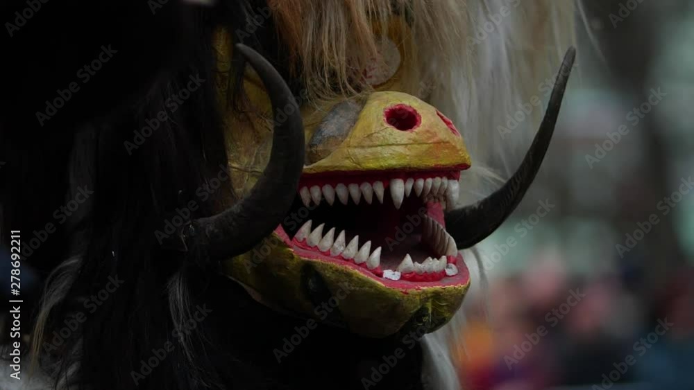 Closer look of the yellow muzzle with big teeths and horns with gun ...