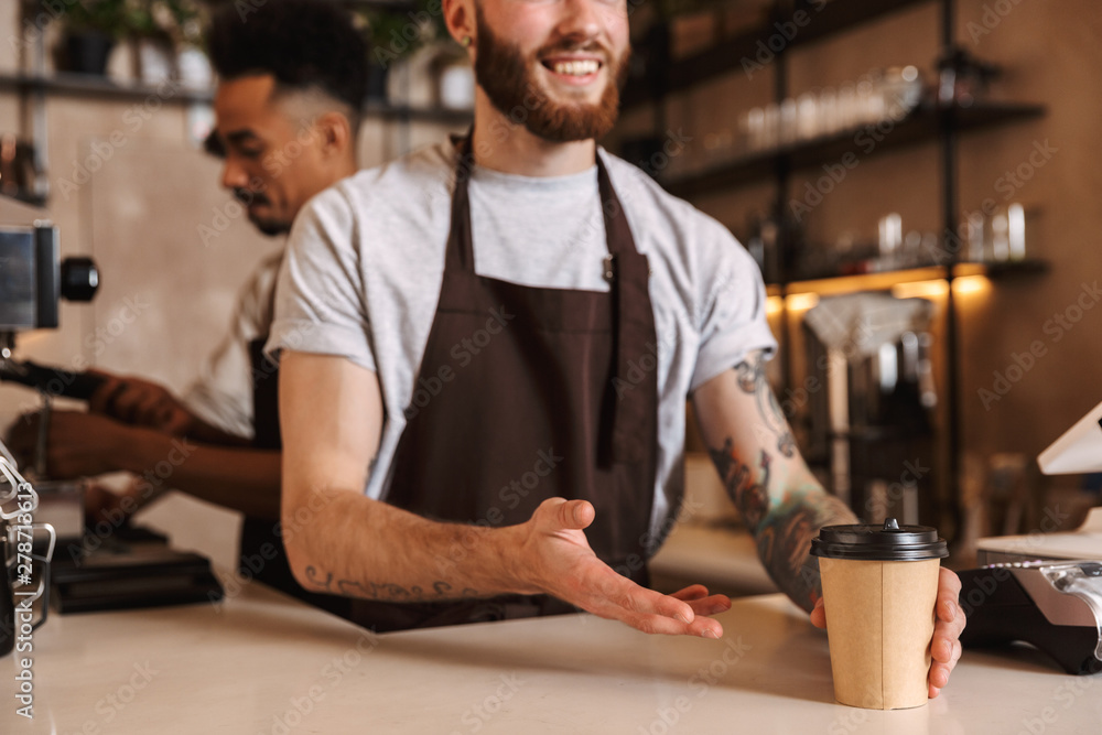 Close up of a male barista giving the order at the cafe Stock Photo ...