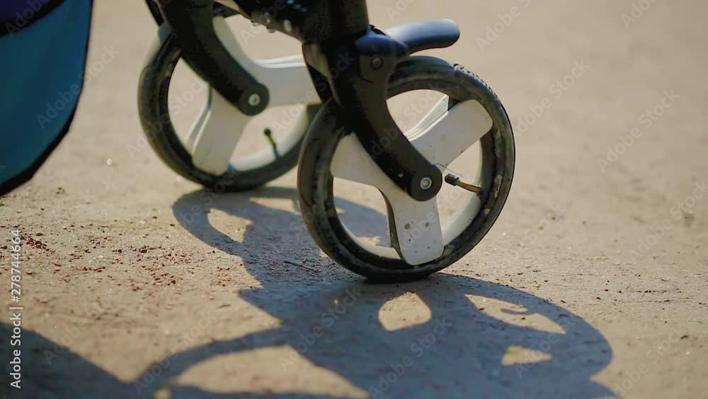 baby stroller on wheels. Close-up wheel. Wheels are rolling back and ...