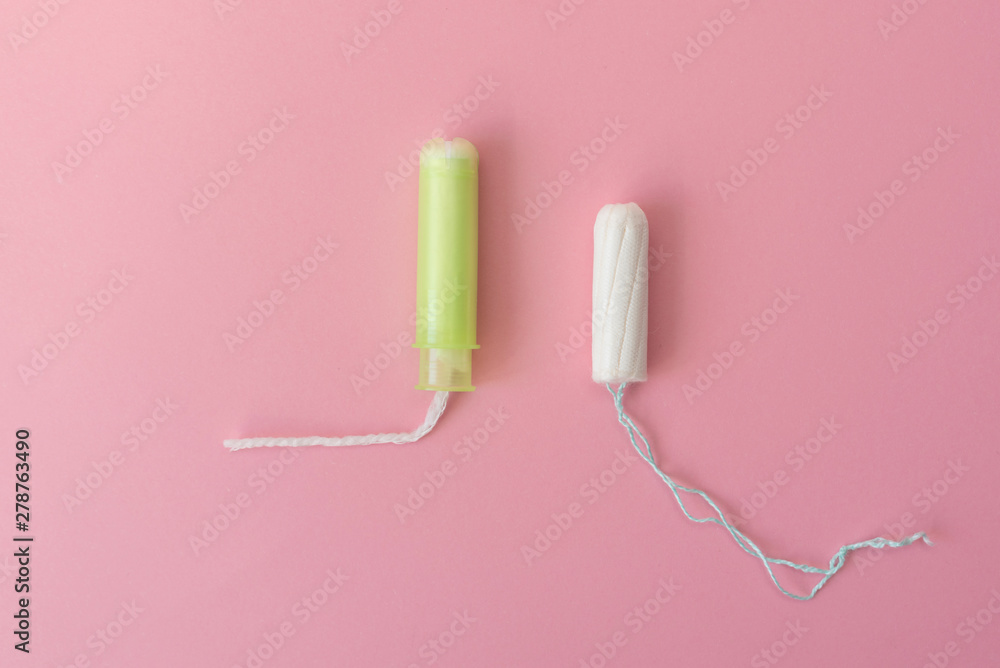 Two cotton tampons with light green applicator and without applicator ...