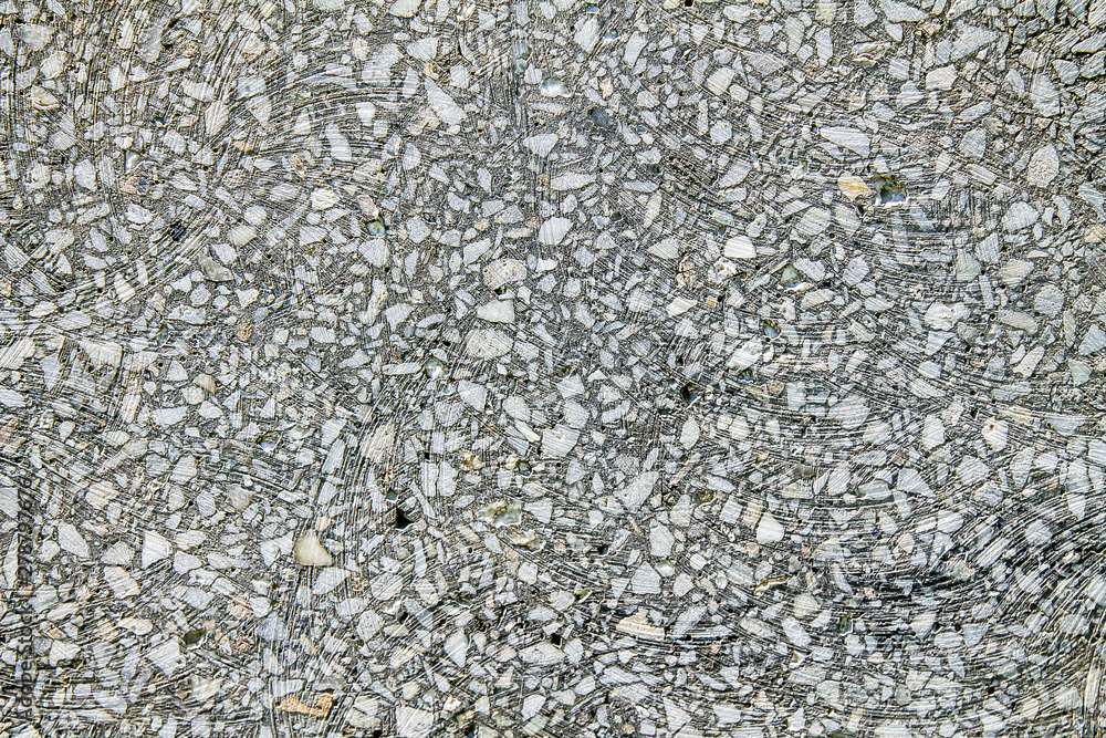 Polished gray concrete wall with white marble chips as a background ...
