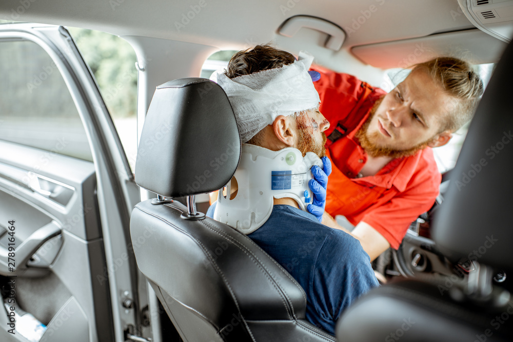 Medic applying bandage on the head of victim with serious damages ...