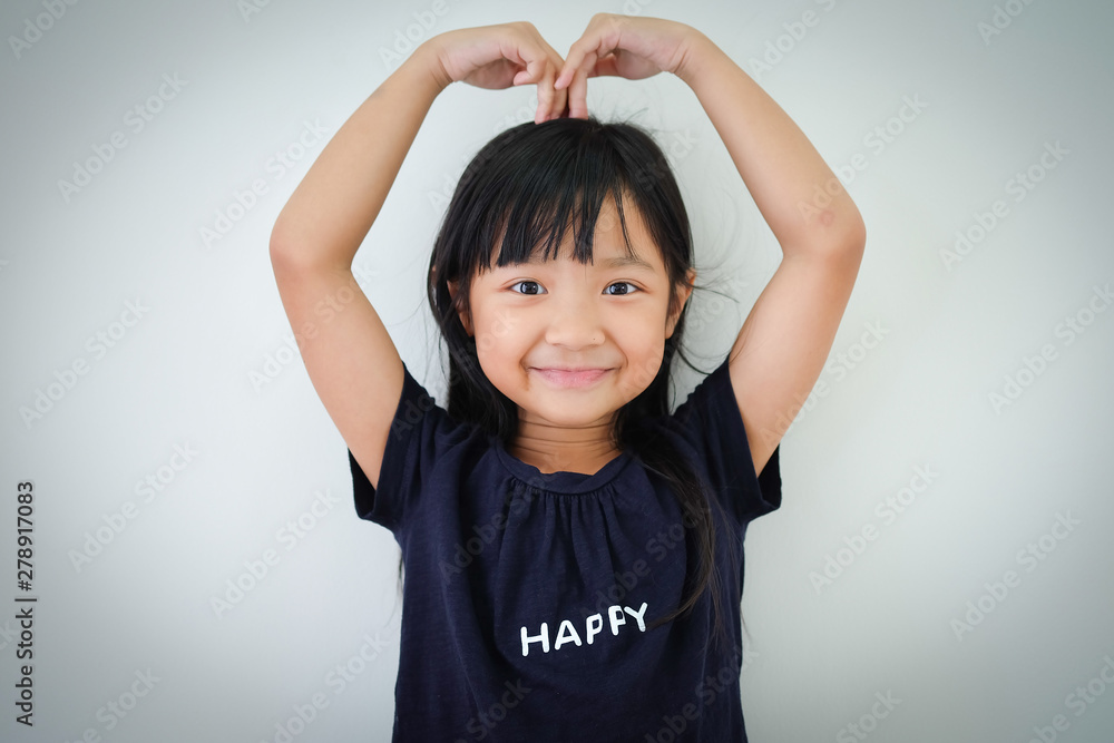 Portrait Asian child girl of smiling resting wearing dark blue t- shirt ...