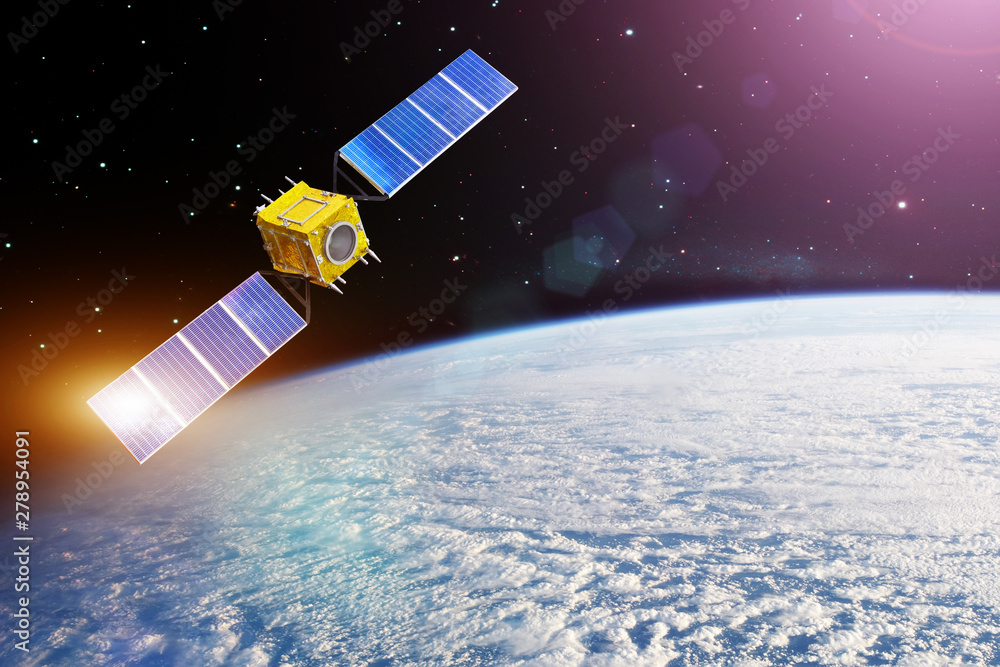 Space satellite orbiting the earth and bright lights sun reflected from ...