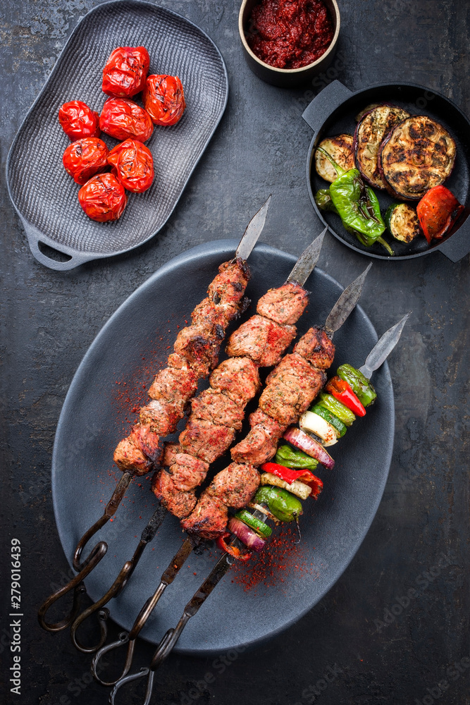 Traditional Russian shashlik on a barbecue skewer with vegetable and ...