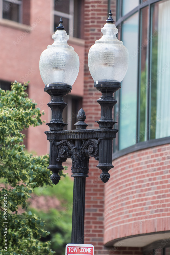 Vintage design of street lamp posts and old brick buildings in the ...