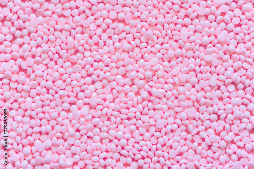 Pile of pink plastic resin granules. Rose granular texture background ...