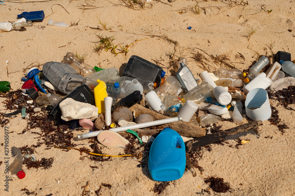 Plastic containers and assorted trash on beach, coastal pollution Stock ...