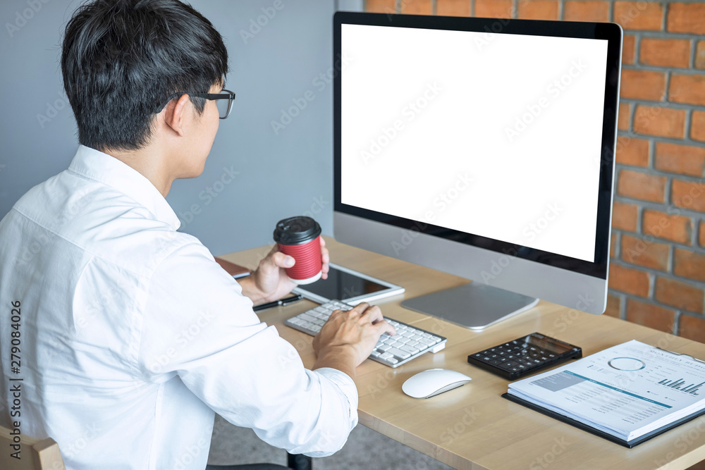 Image of Young man working in front of the computer laptop looking at ...