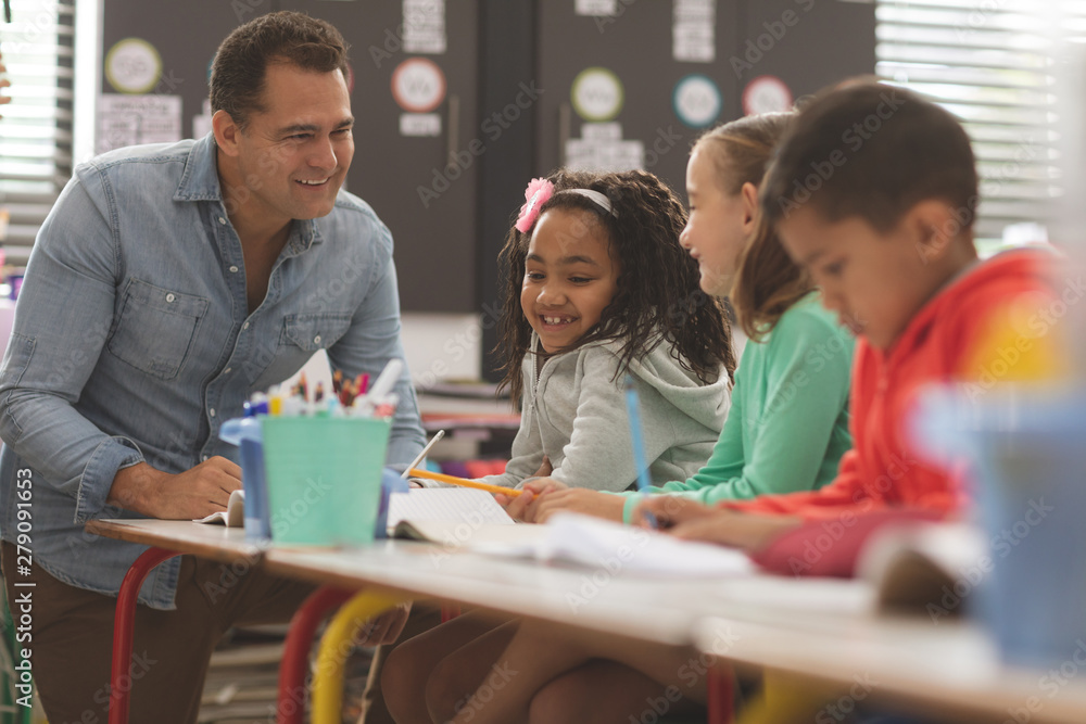 Surface level view of a teacher interacting with school kids while ...