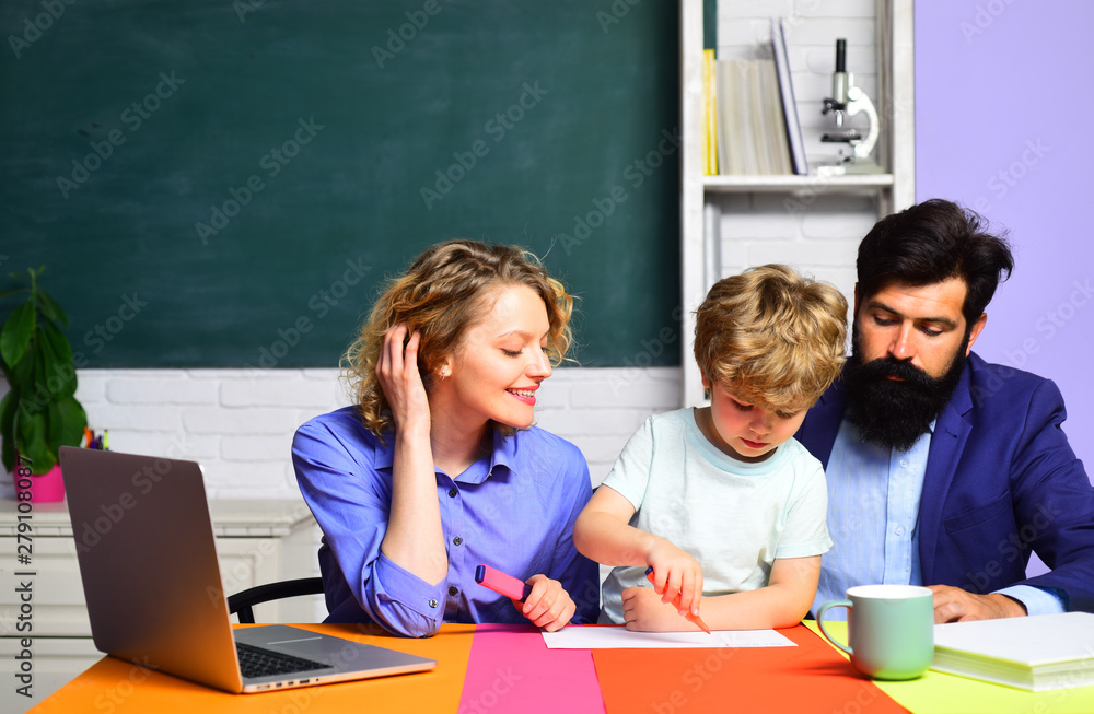 Children education. Schoolboy and his parents making homework. Back to ...