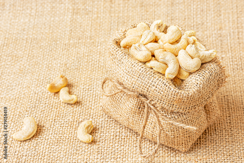 Healthy cashew nuts in a hemp sack and on a burlap background. Food ...