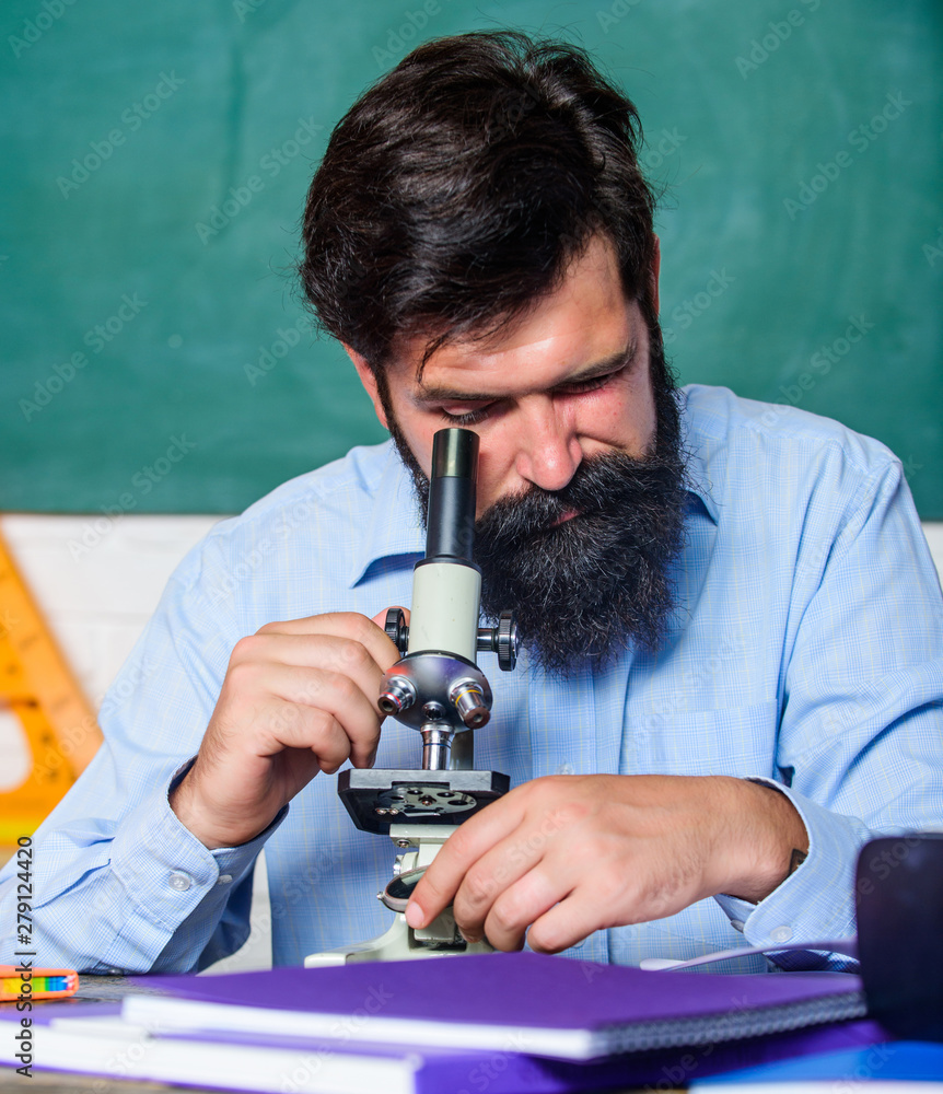 Set up microscope. Teacher sit desk with microscope. Man bearded ...