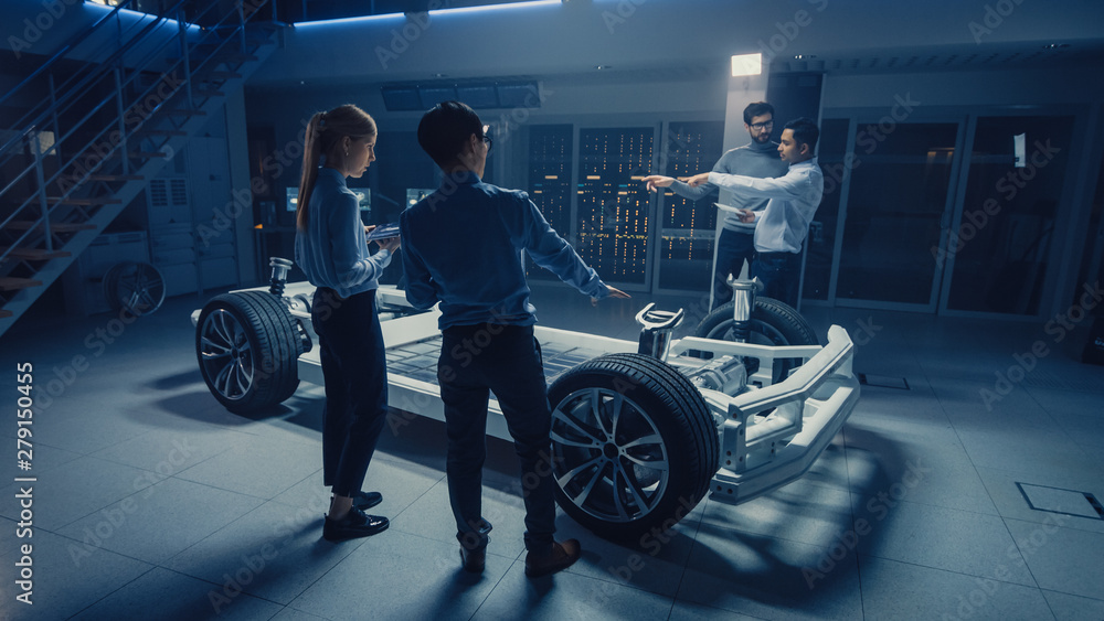 Team of Automotive Engineers Discussing and Designing Electric Car ...