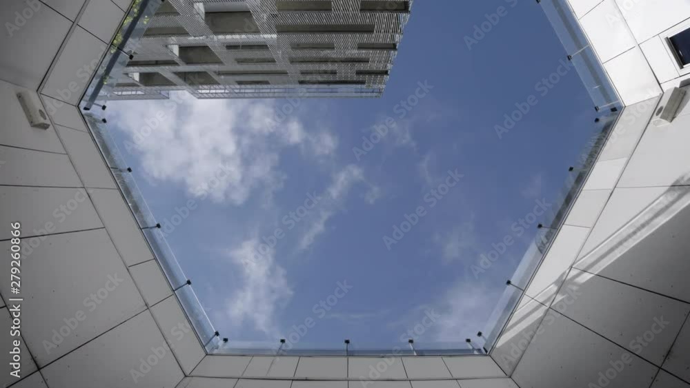 4K anamorphic video with forward and tilt motion of a blue cloudy sky ...